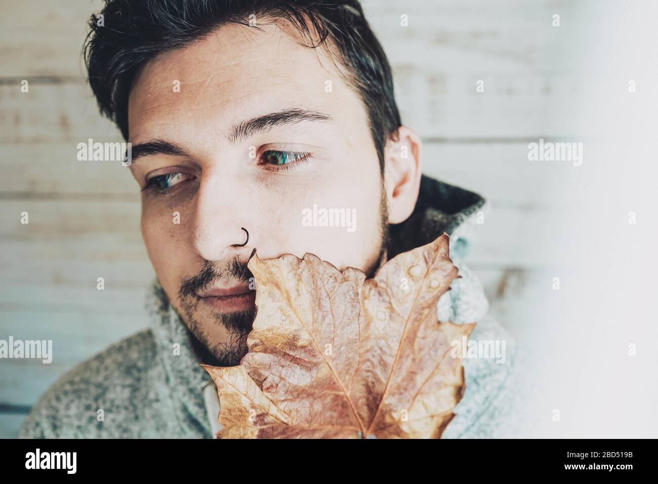 Young man covering his face with a dry leaf Stock Photo - Alamy