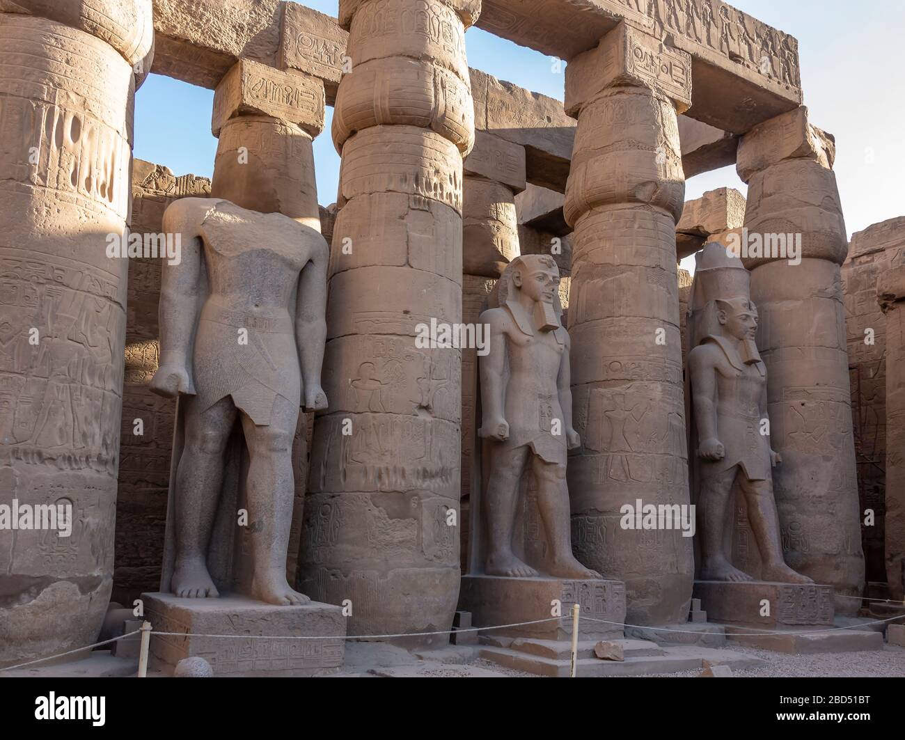 Standing colossal statues of Ramesses II at Luxor Temple Stock Photo ...