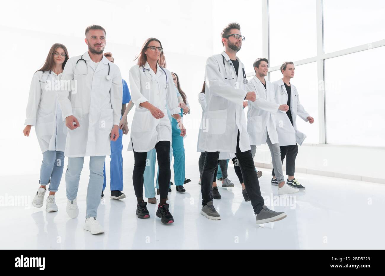 large group of paramedics confidently marching to help Stock Photo - Alamy