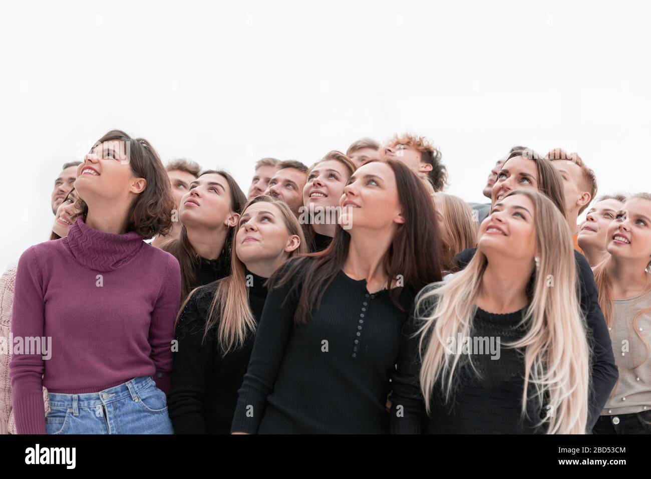 close up. happy young people looking up somewhere Stock Photo - Alamy