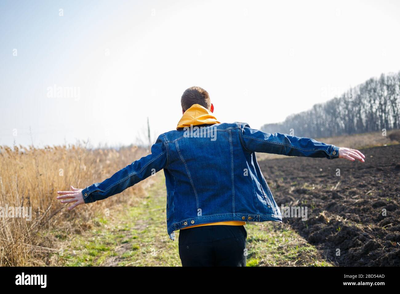 Smiling man enjoying wind blowing in forest. Happy man feeling joy ...