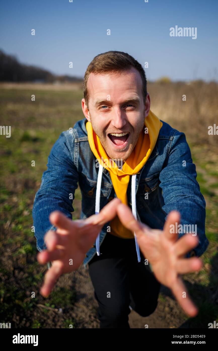 Smiling man enjoying wind blowing in forest. Happy man feeling joy ...