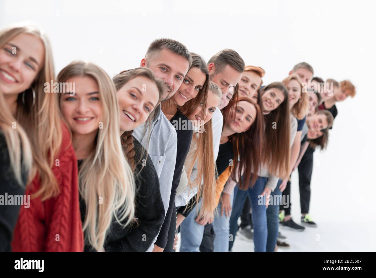 group of cheerful young people standing behind each other Stock Photo ...