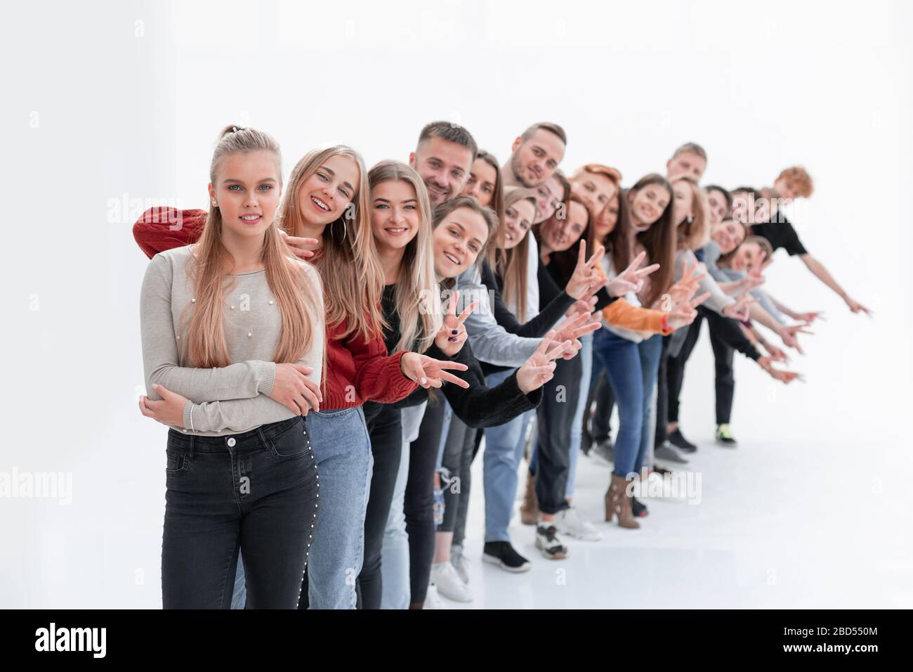 group of cheerful young people standing behind each other Stock Photo ...