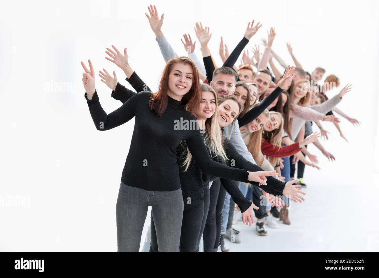 confident guy standing first in the column of young people Stock Photo ...