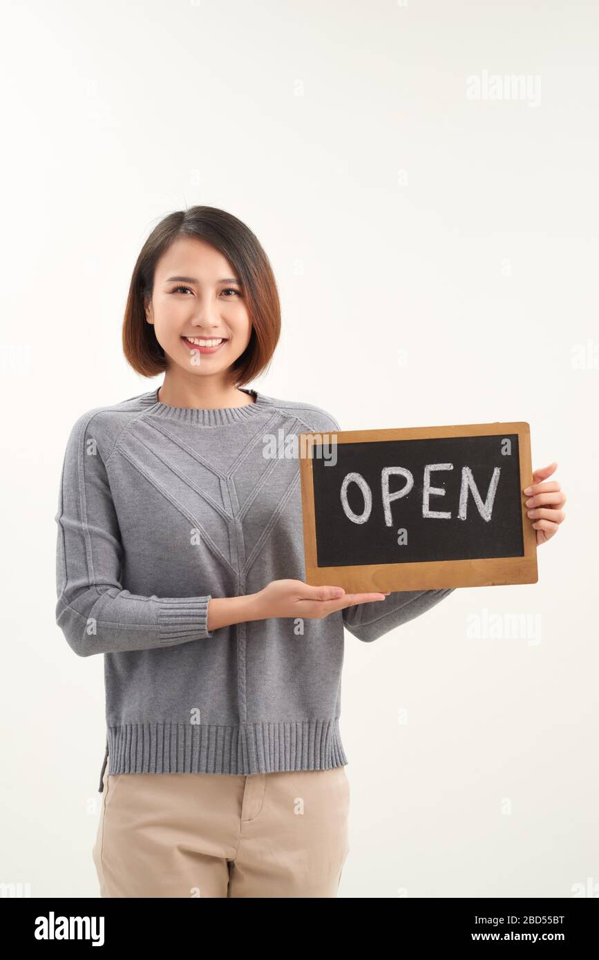 It's open here. A smiling woman is holding a sign with the inscription ...