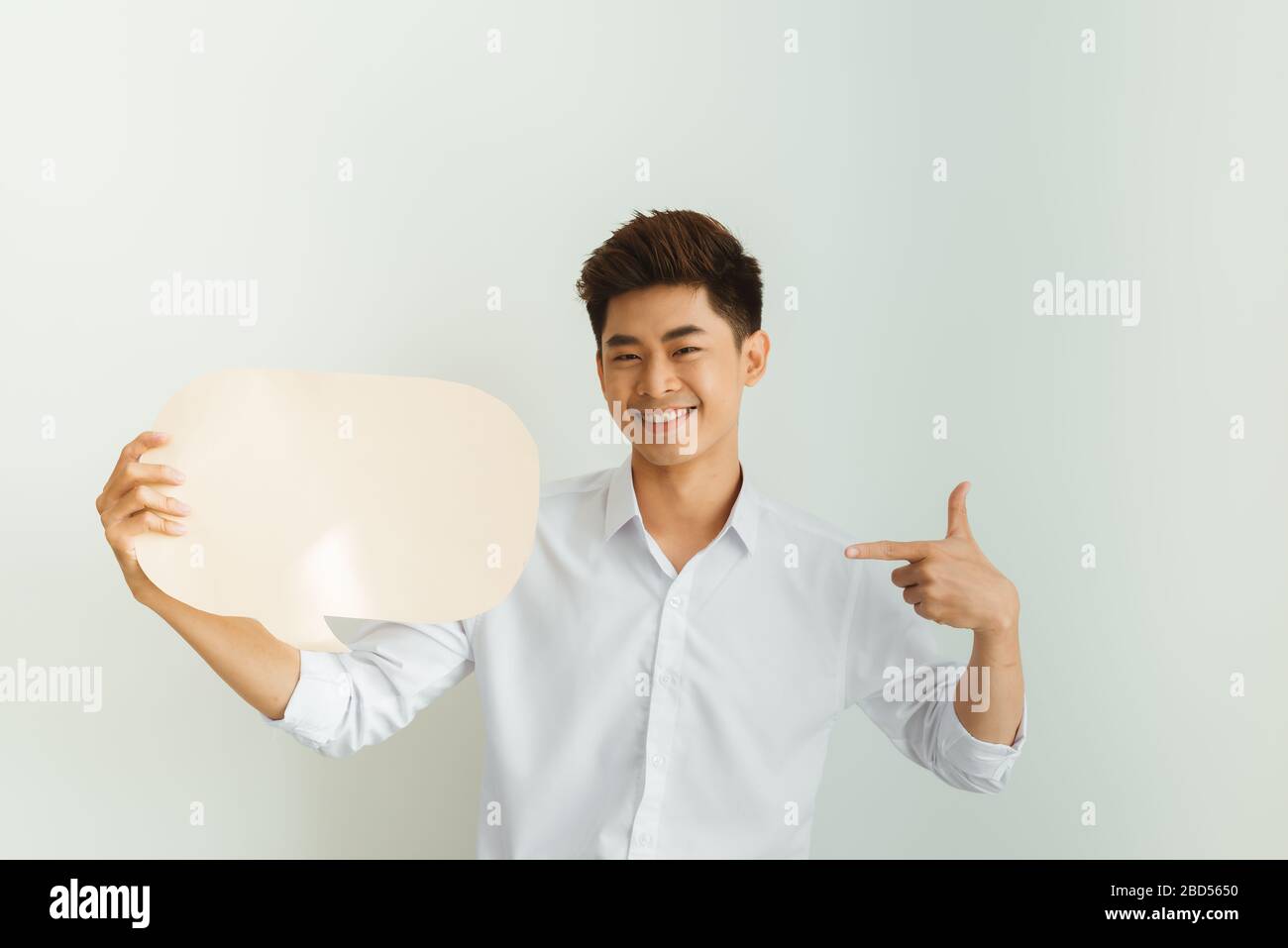 Handsome asian man holding a cardboard speech bubble paper Stock Photo ...