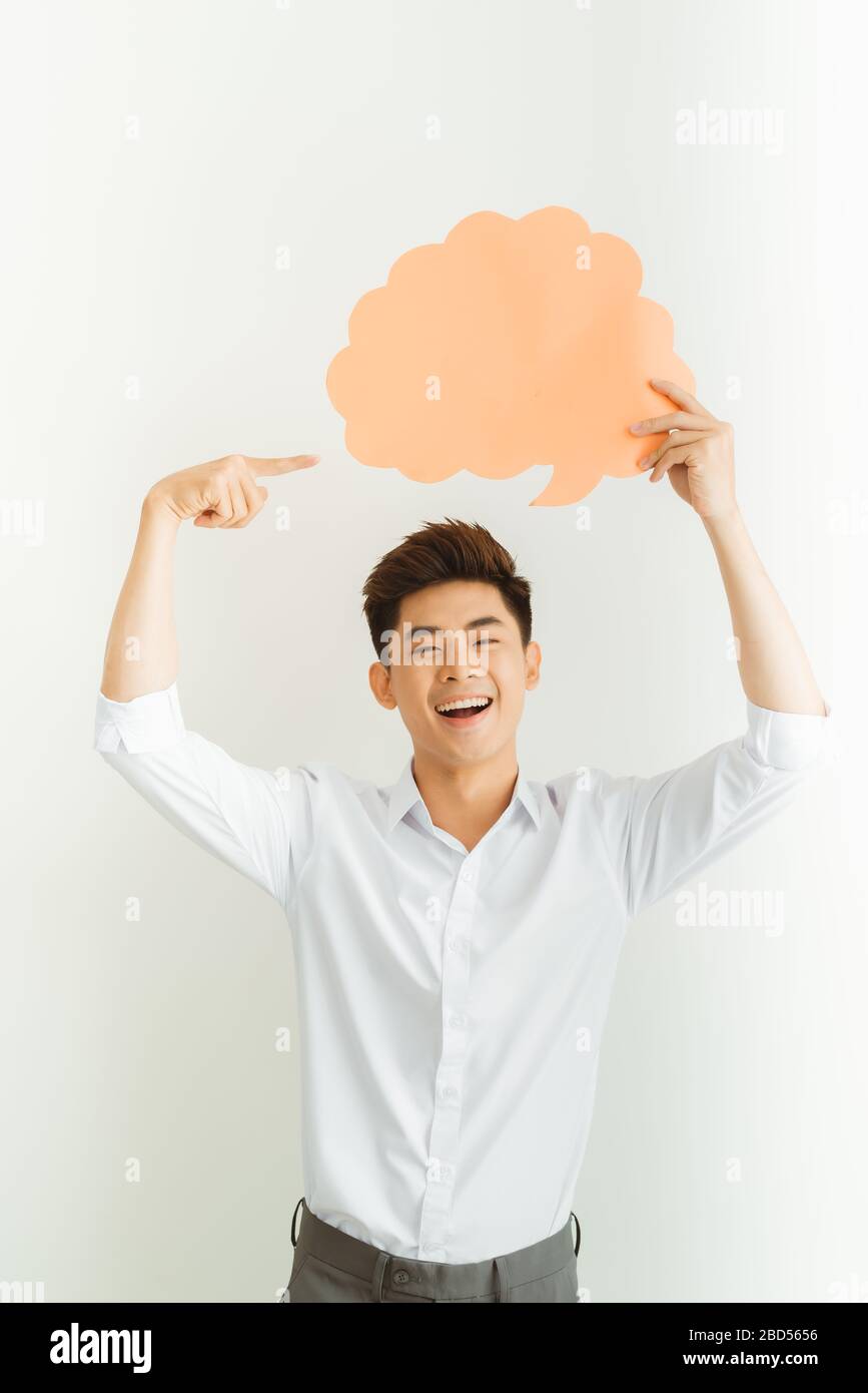 Portrait of an excited young man holding empty speech bubble isolated ...