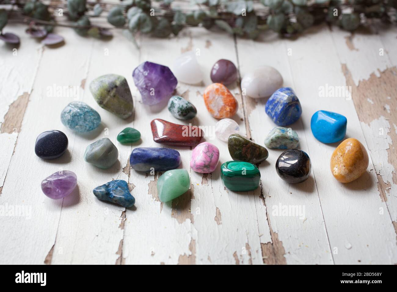 A selection of beautiful gemstones photographed against a white rustic ...