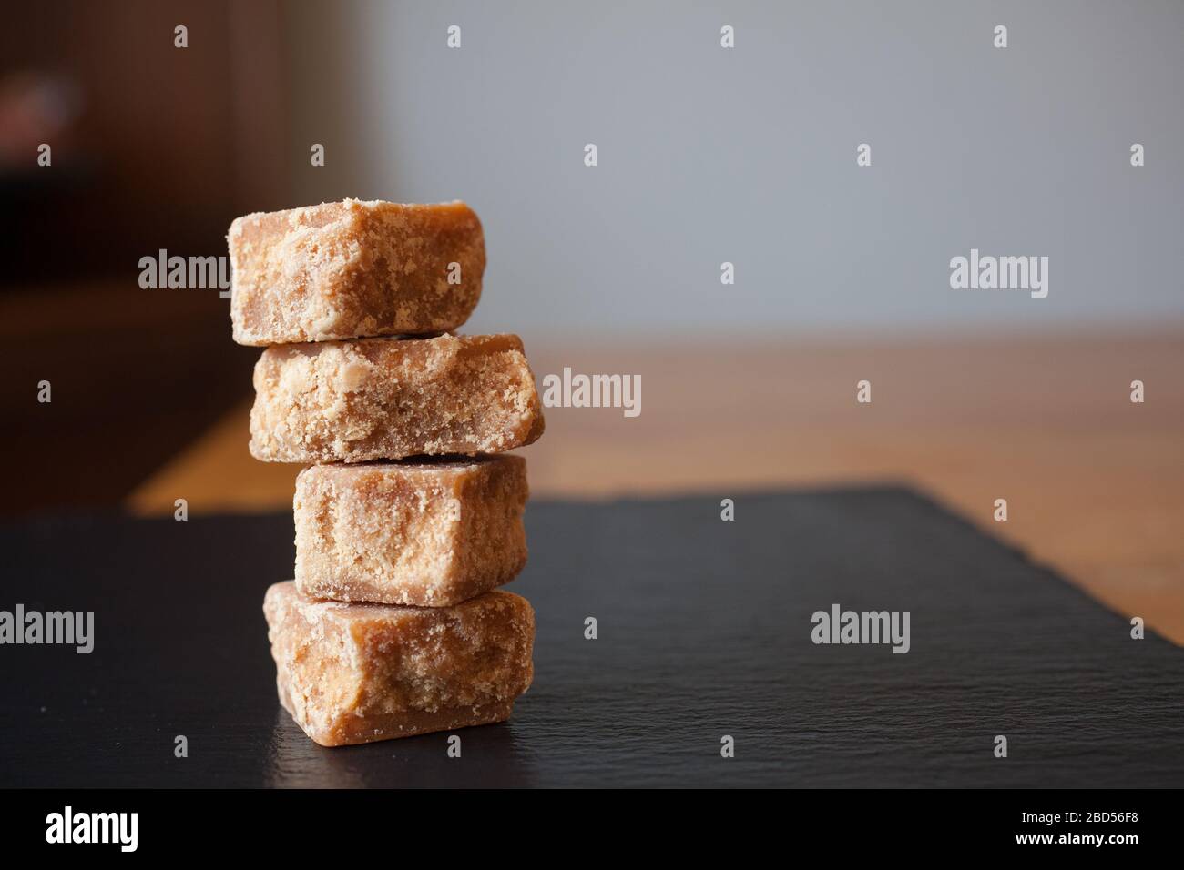 4 pieces of fudge stacked together on a piece of black slate Stock ...