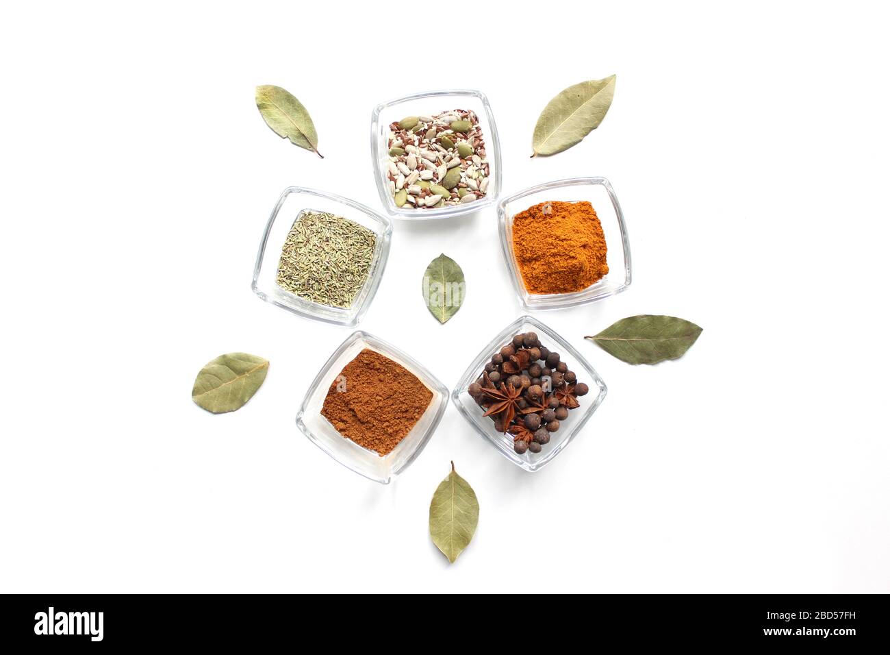Top view mix indian spices and herbs glass pots on white background ...