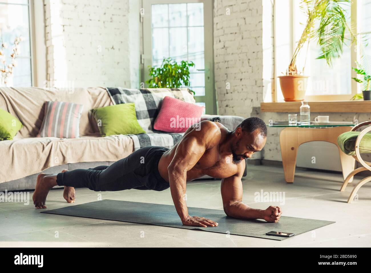 African-american man teaching at home online courses of fitness ...