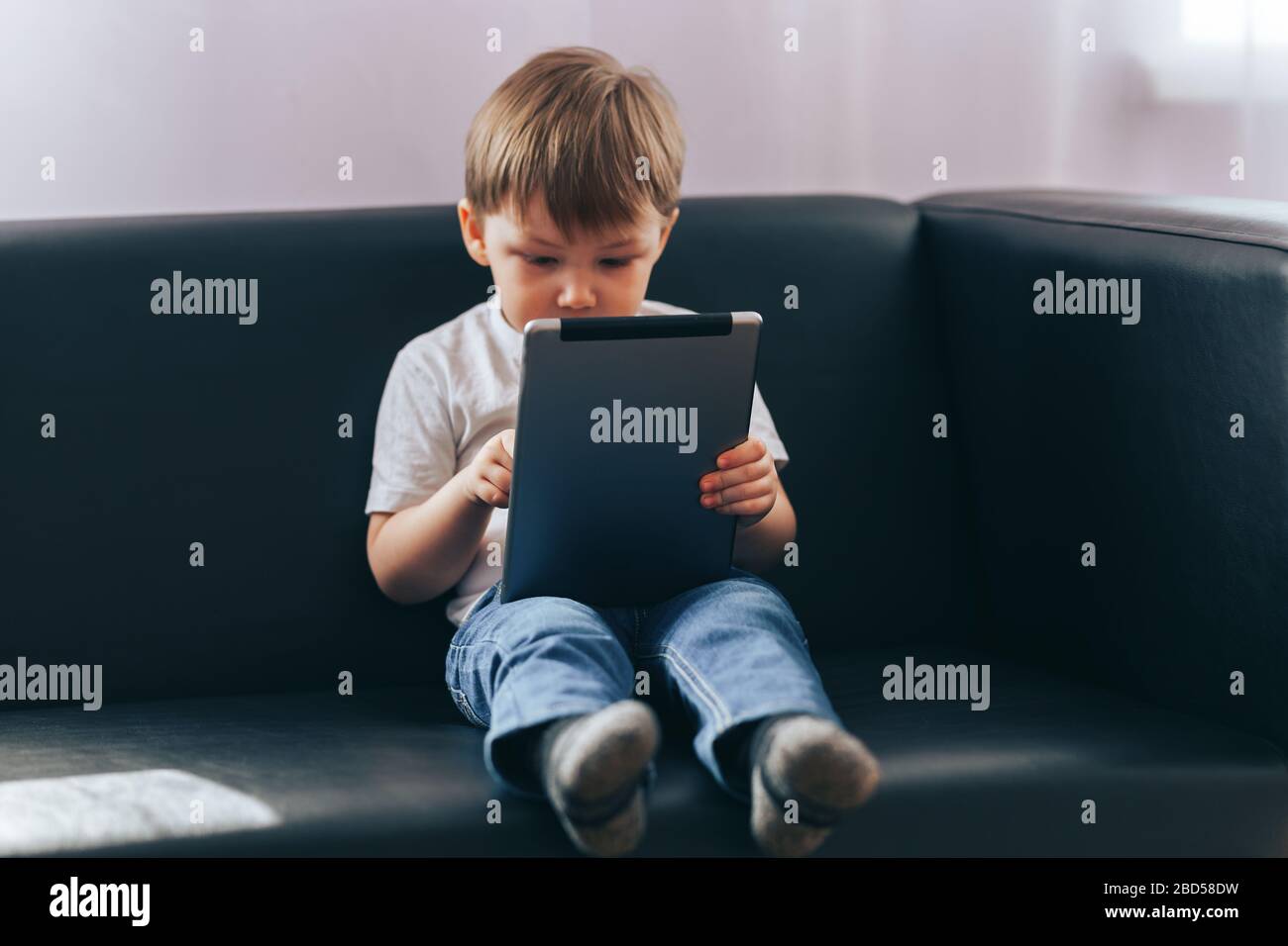 Little boy with a tablet Stock Photo - Alamy