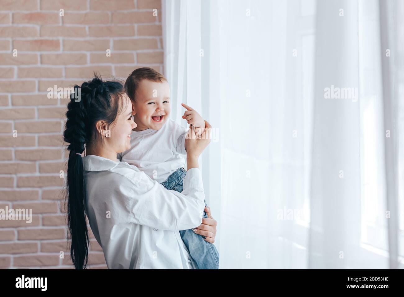 Young girl hugs little boy Stock Photo - Alamy
