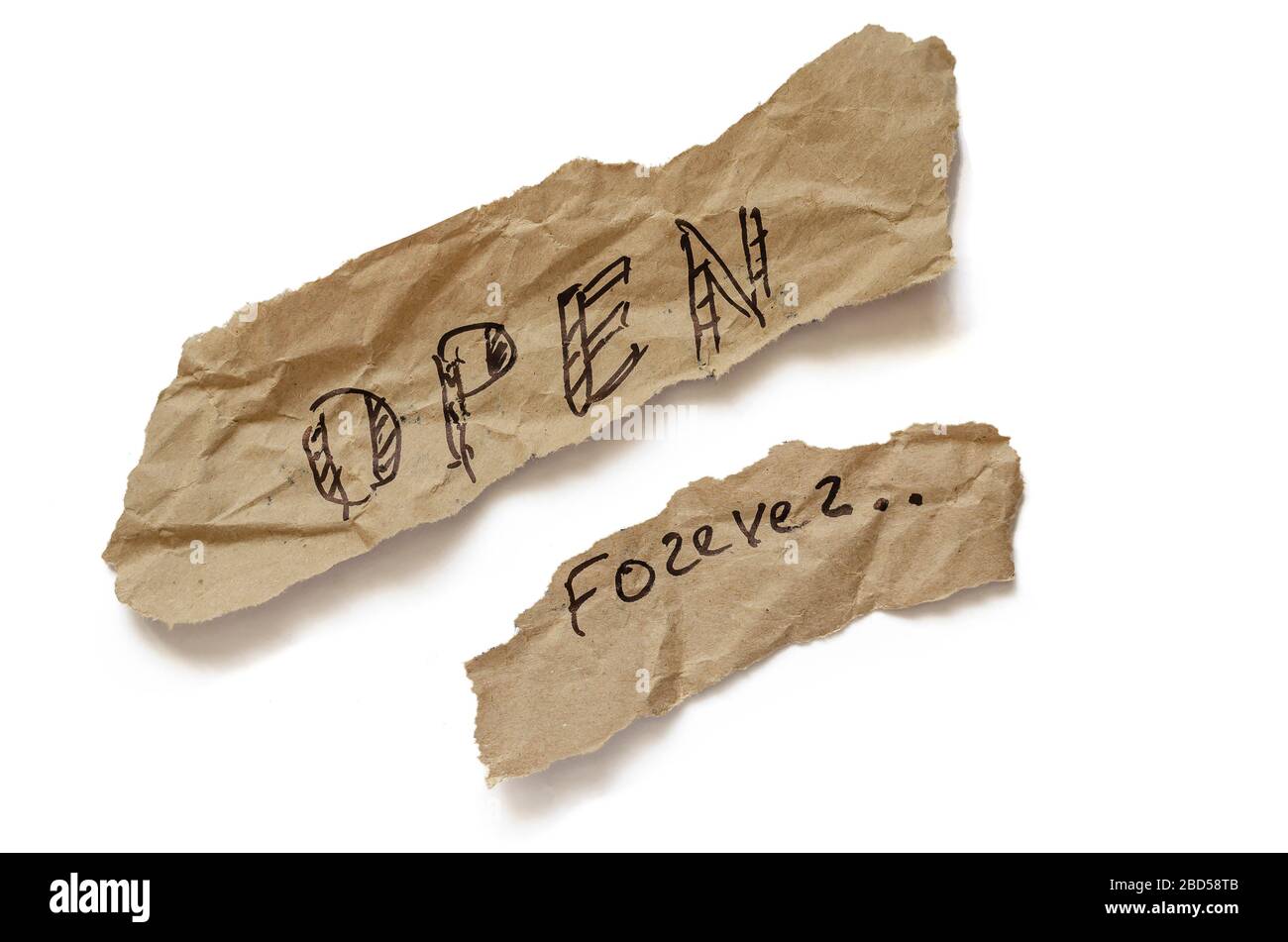 Pieces of brown paper with handwritten inscription on a white ...