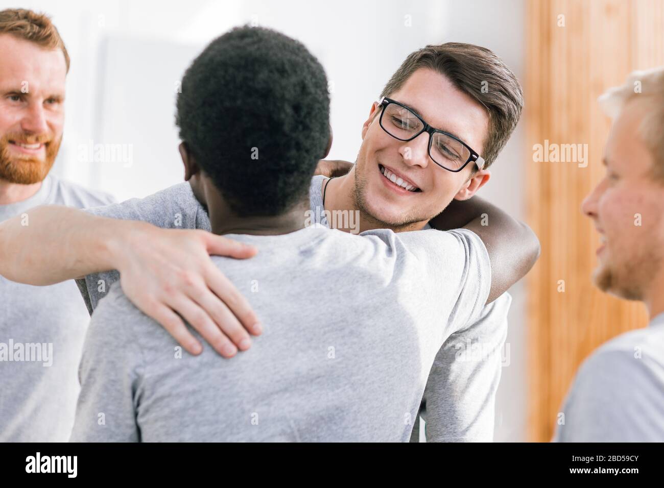 two happy student friends hugging each other Stock Photo - Alamy