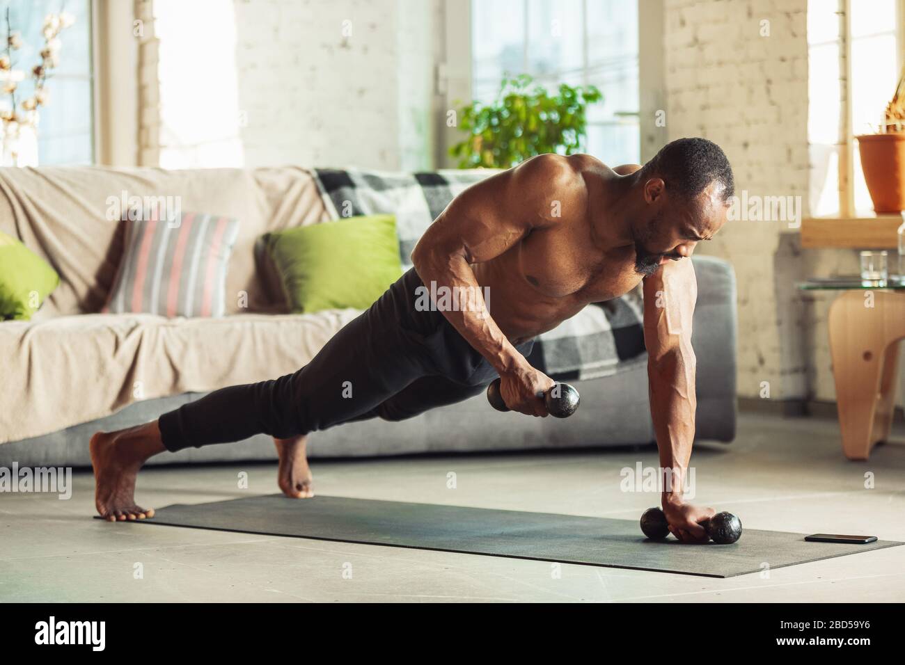 African-american man teaching at home online courses of fitness ...