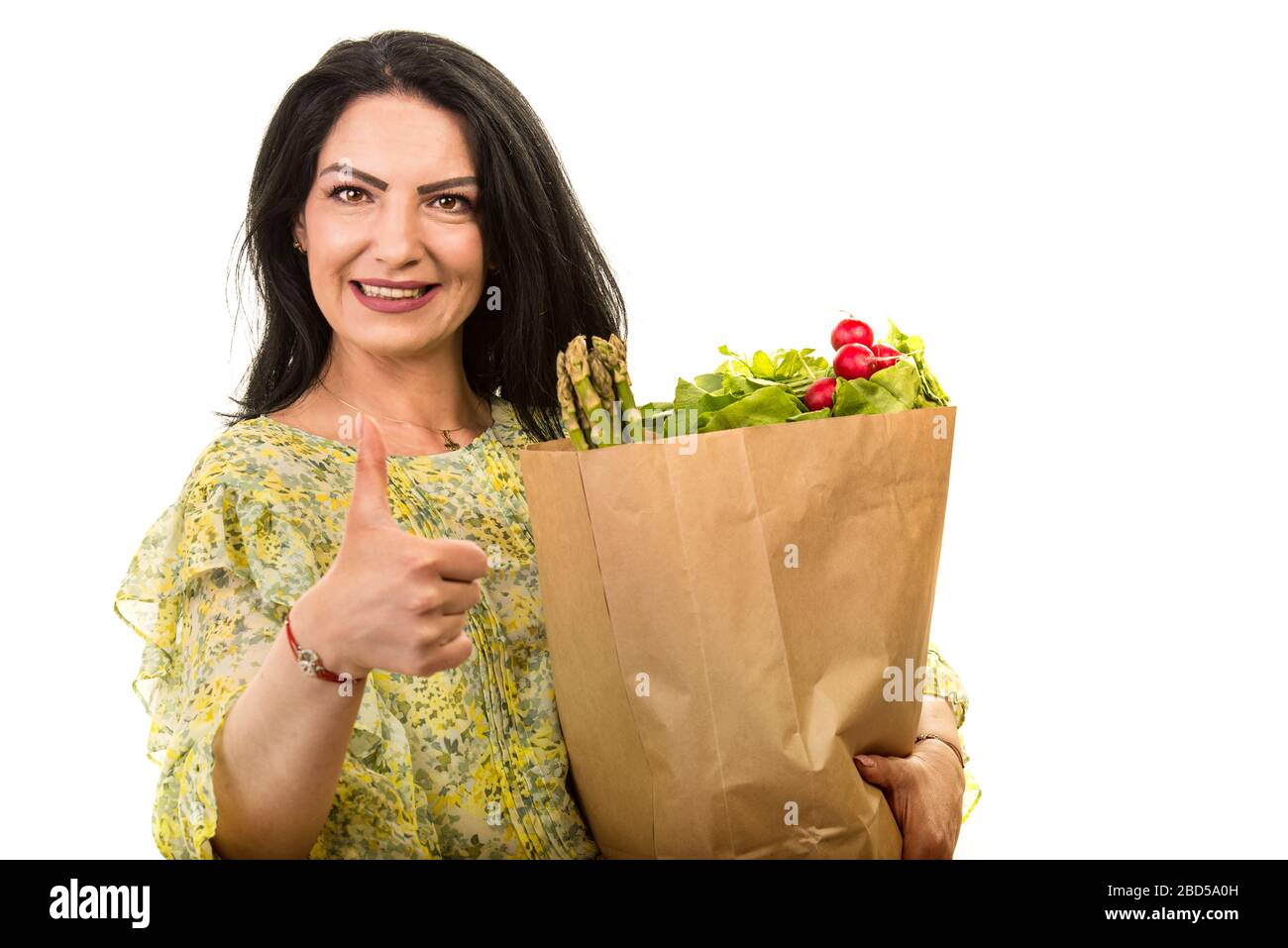 Successful shopper woman giving thumb up isolated on white background ...