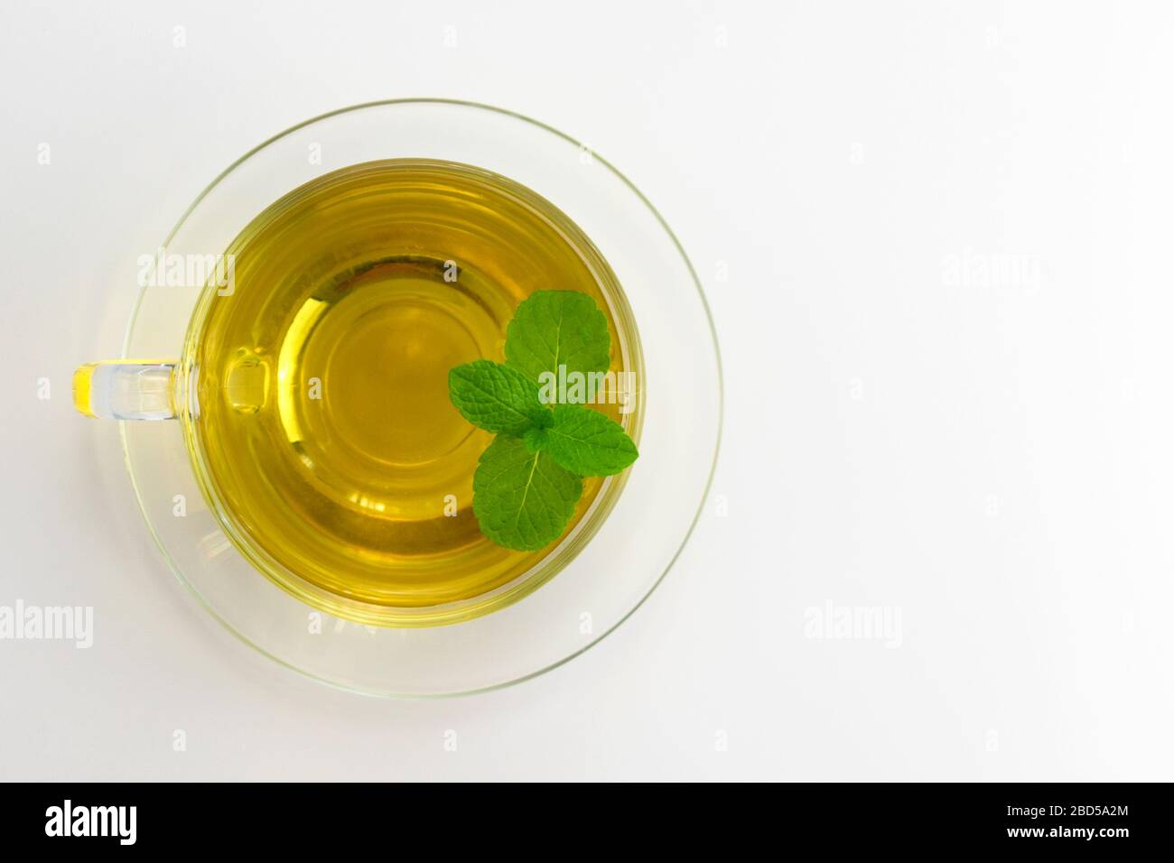 Mint tea in a transparent cup is isolated on a white background. Flat ...