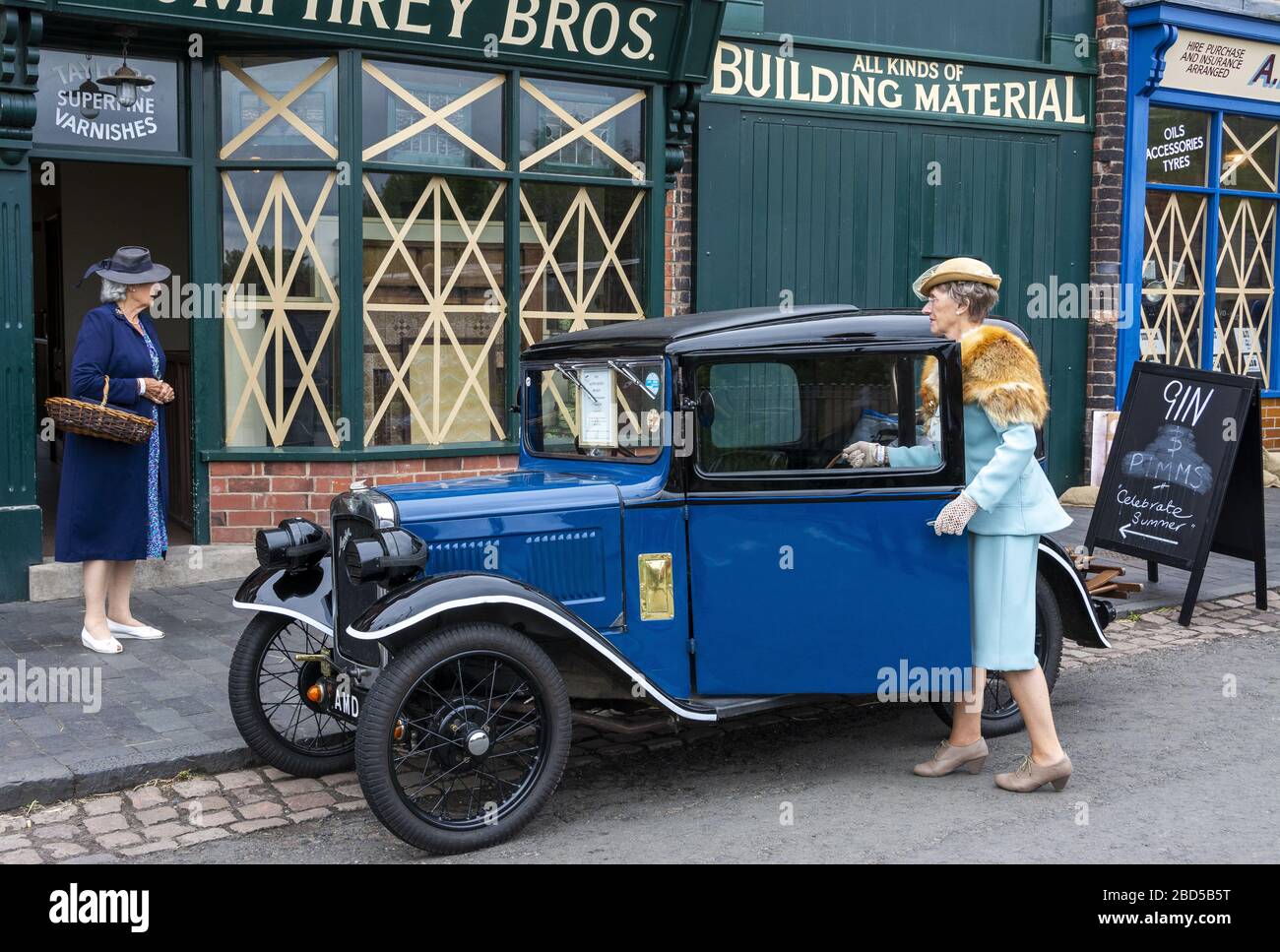 Dressed up lady getting into classic car at the 1940's weekend at the ...