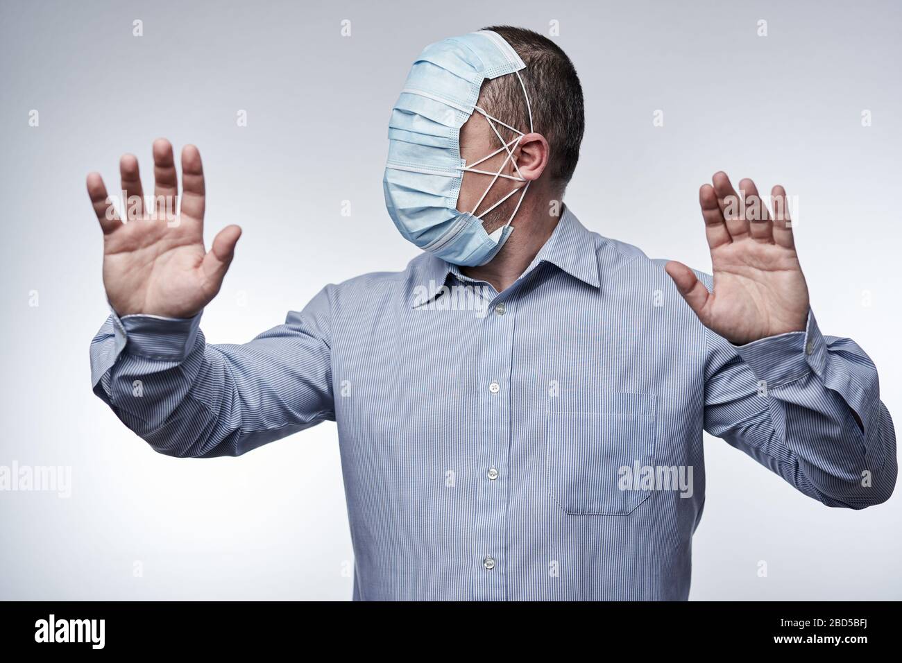 Man with exaggerated mask protection, whole face covered, making him ...