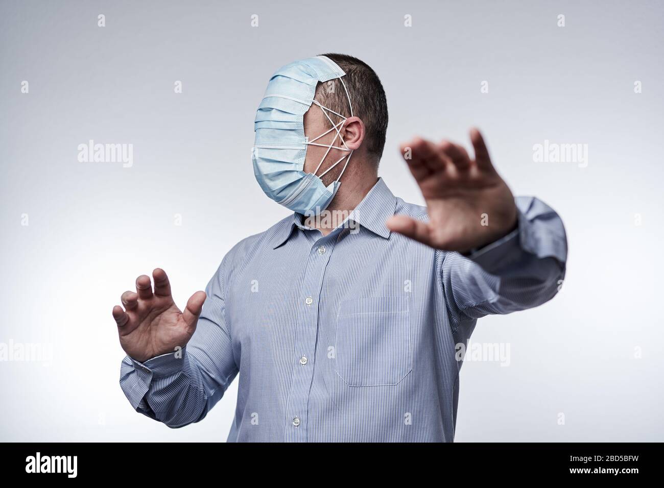 Man with exaggerated mask protection, whole face covered, making him ...