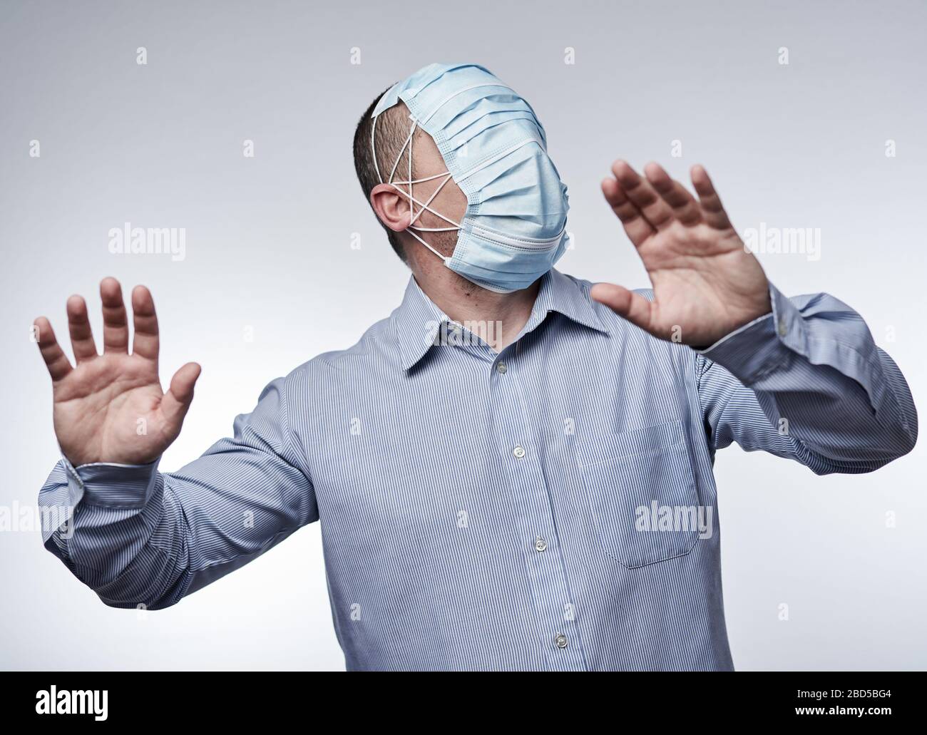 Man with exaggerated mask protection, whole face covered, making him ...