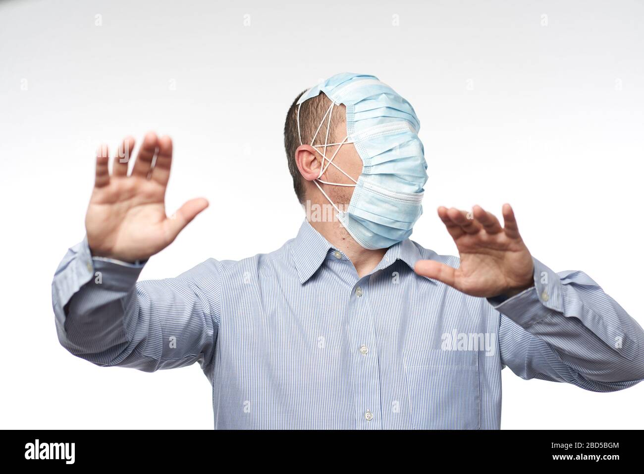Man with exaggerated mask protection, whole face covered, making him ...