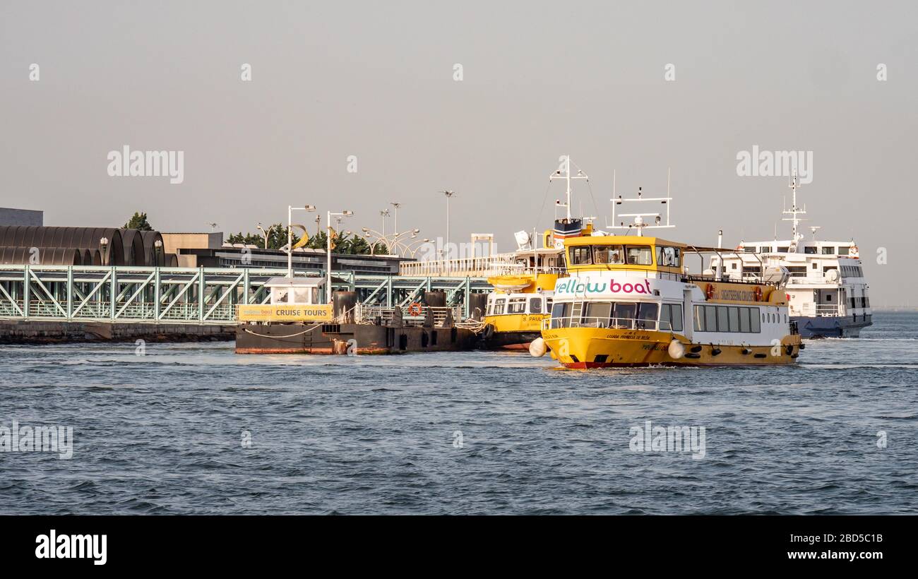 A Yellow Boat tour ship departing from its dock at Terreiro do Paco on ...