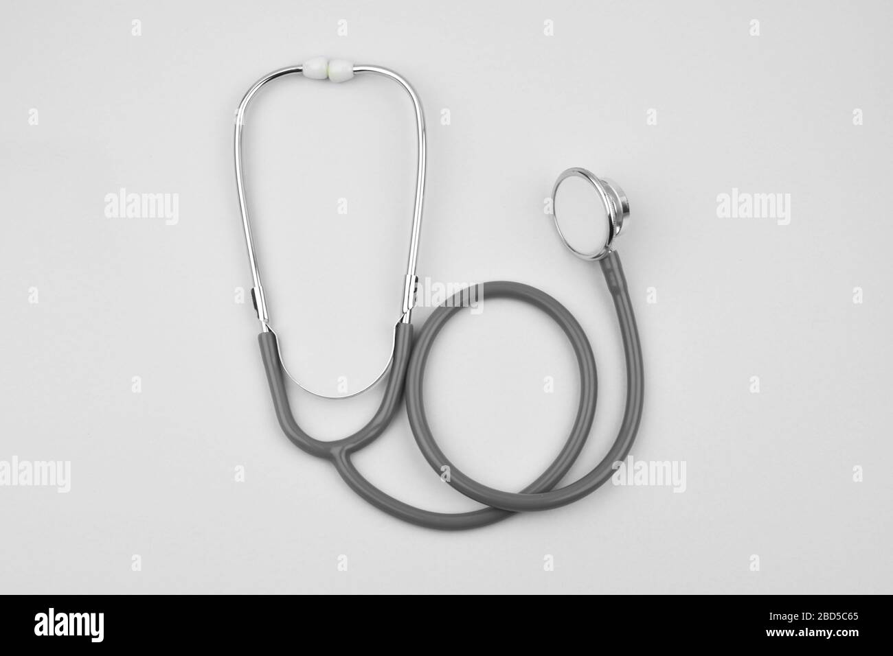 One single normal stethoscope isolated on top of a white color empty ...