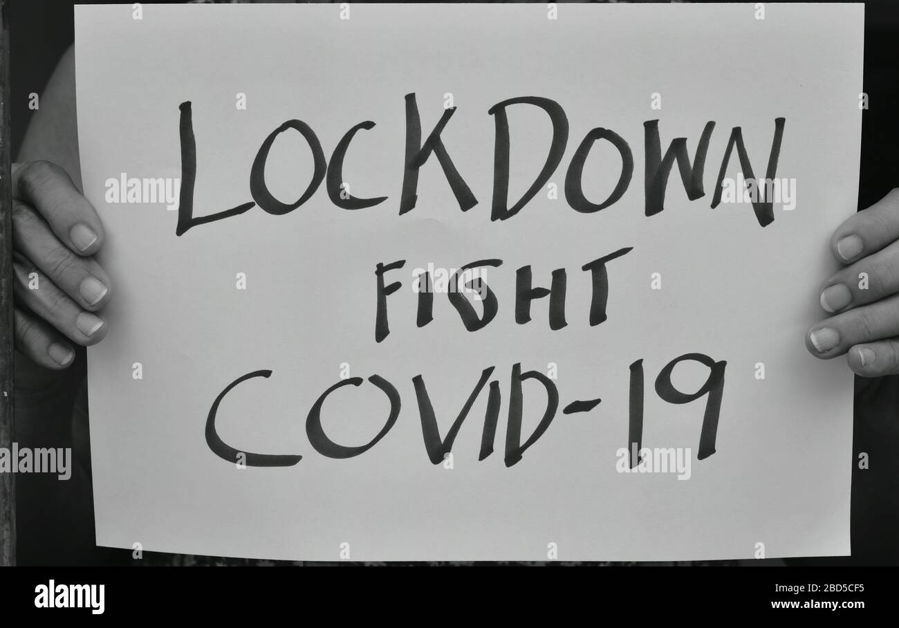 hand holding white paper wrote lockdown and fight to quarantine from ...