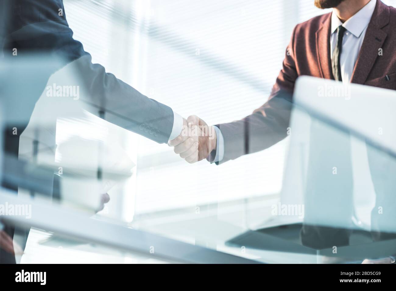 bottom view. handshake of business partners over the Desk Stock Photo ...