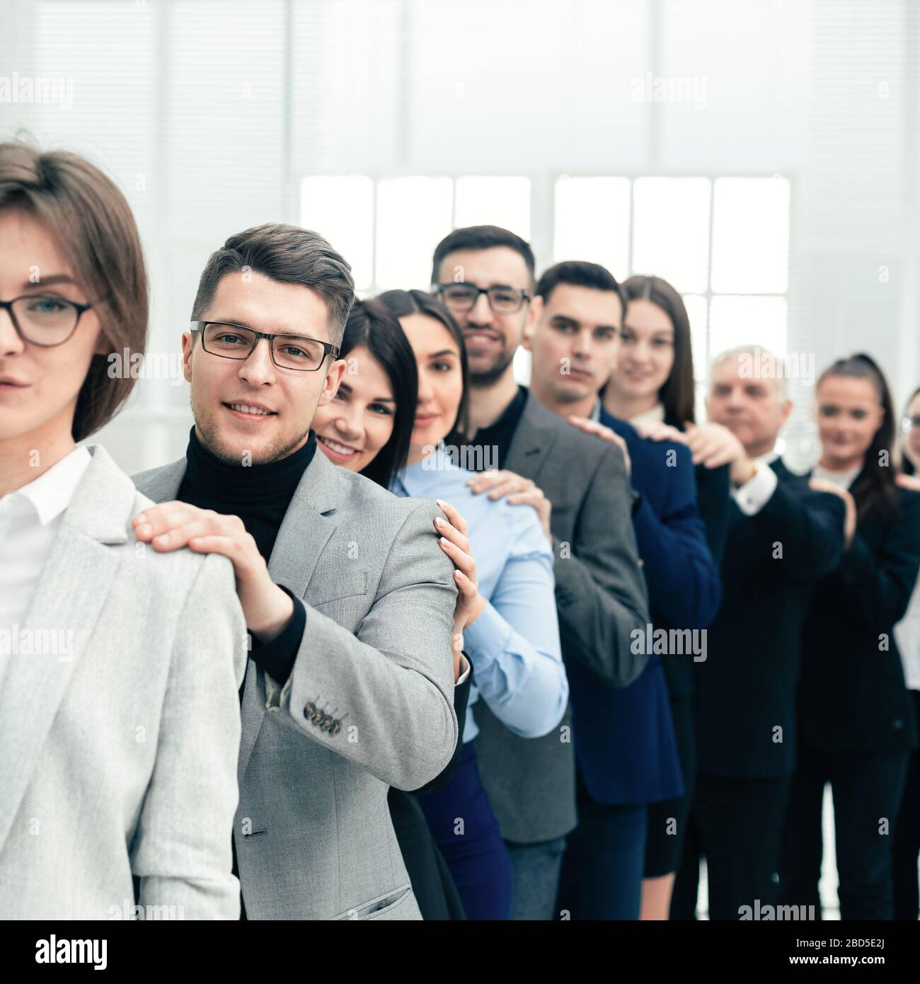 group of young business people standing behind each other Stock Photo ...