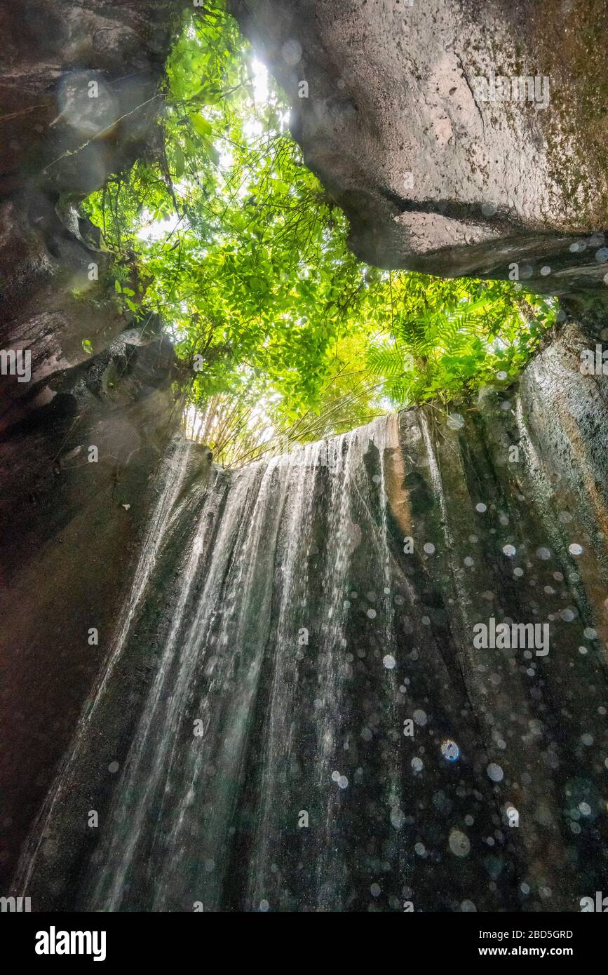 Vertical view of the Tukad Cepung waterfalls in Bali, Indonesia Stock ...