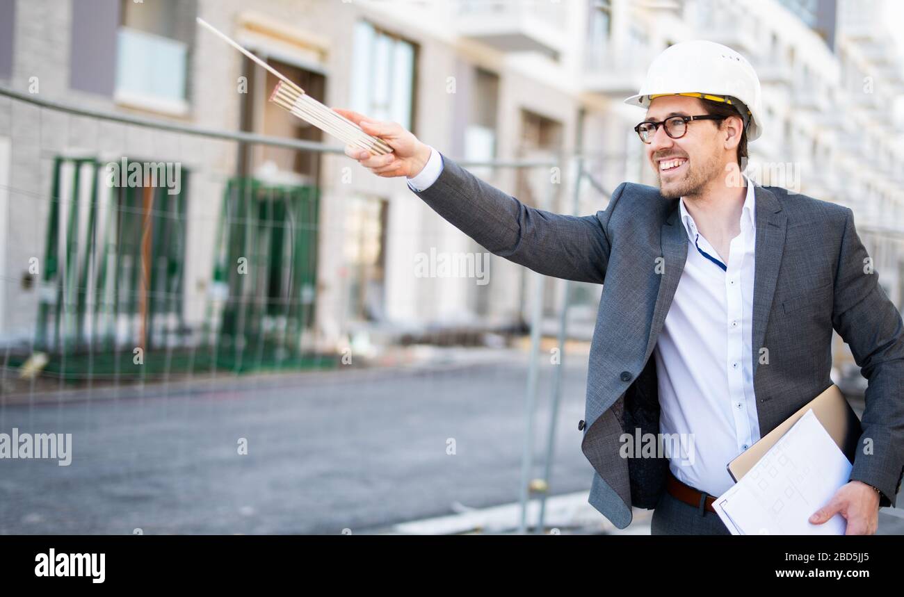 Young and attractive architect / civil engineer at work on a ...