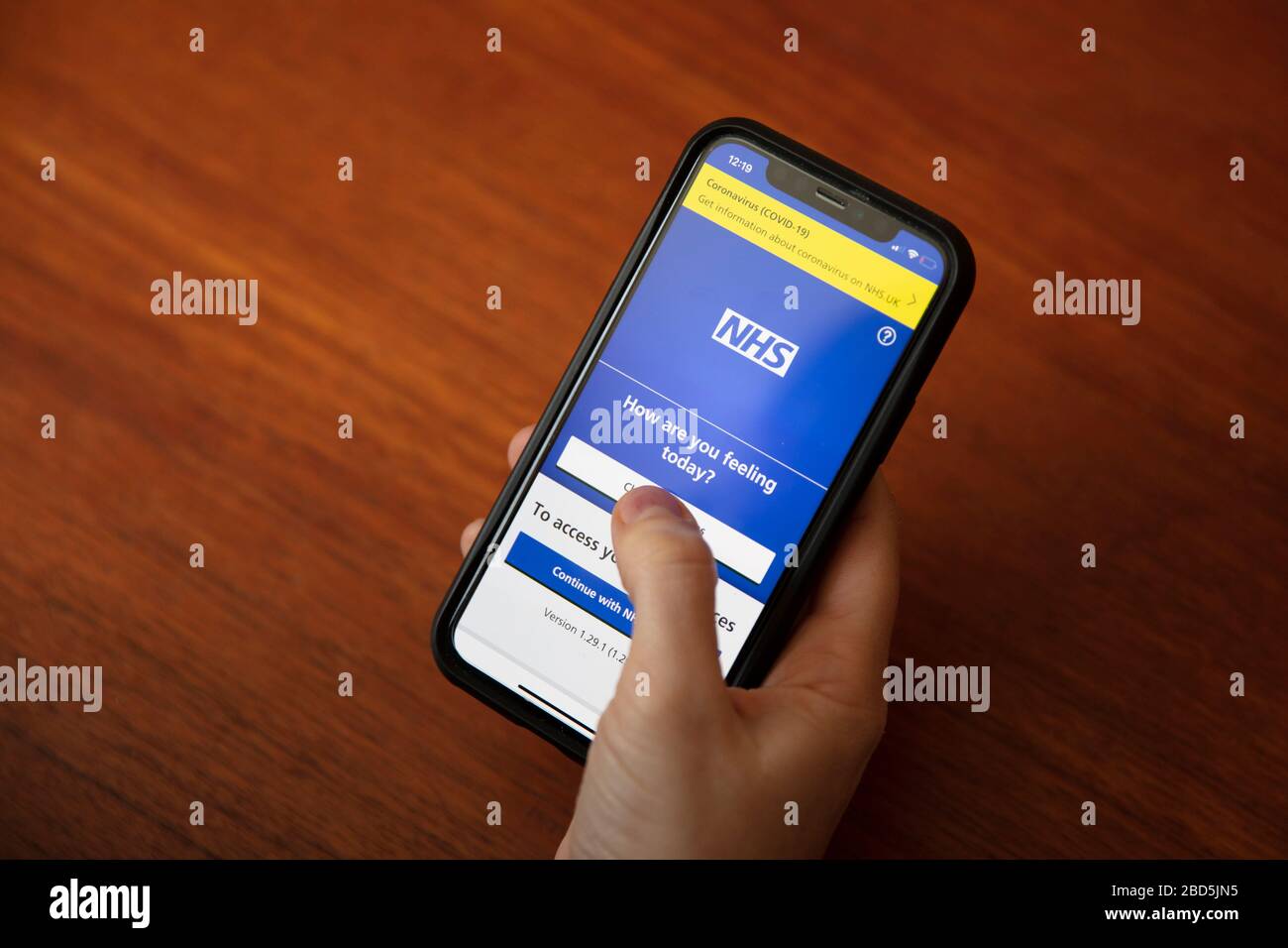 LONDON, UK - April 6th 2020: A person using the NHS healthcare ...