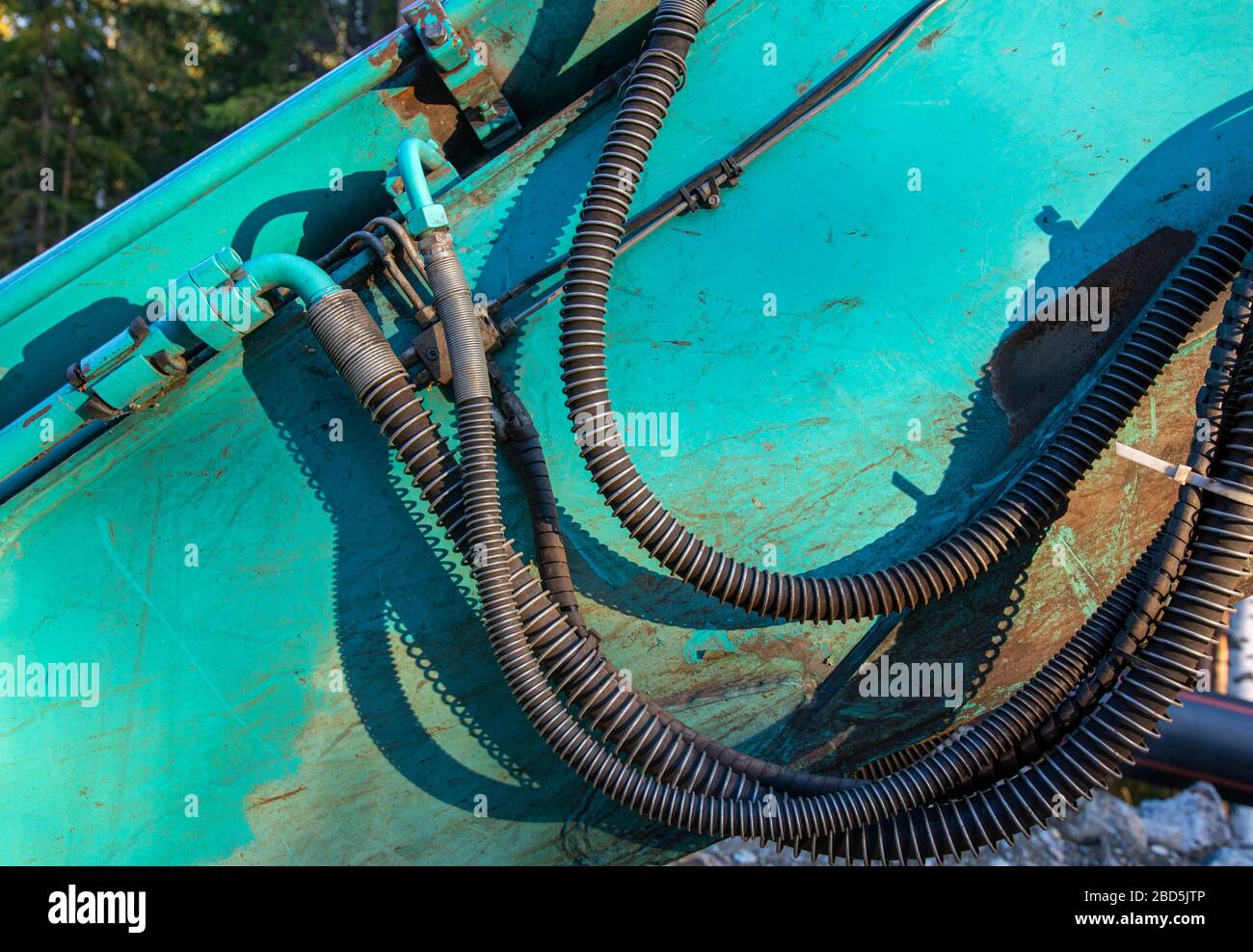 Protected hydraulics rubber hoses on a digger boom Stock Photo - Alamy