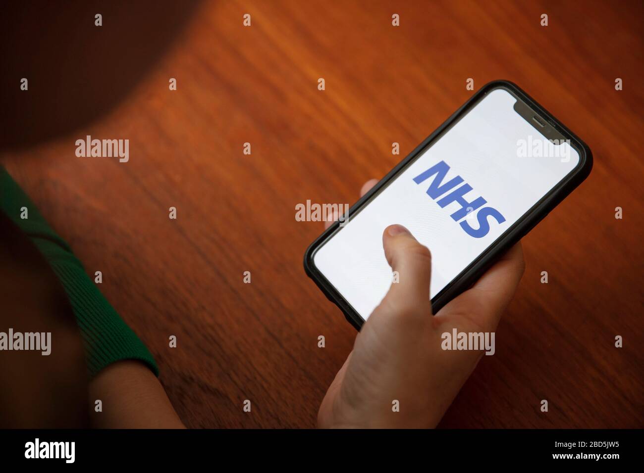 LONDON, UK - April 6th 2020: A person using the NHS healthcare ...