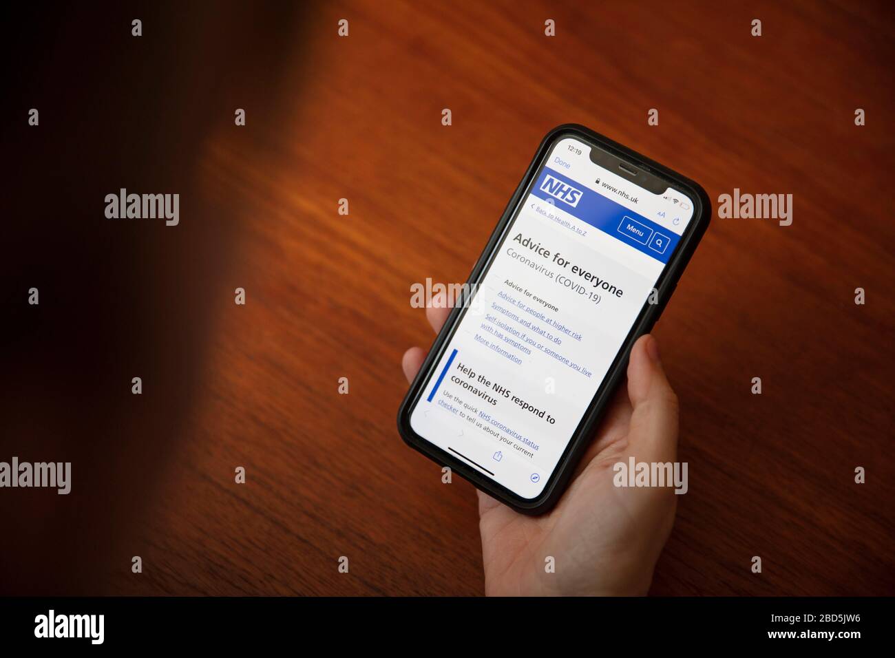 LONDON, UK - April 6th 2020: A person using the NHS healthcare ...