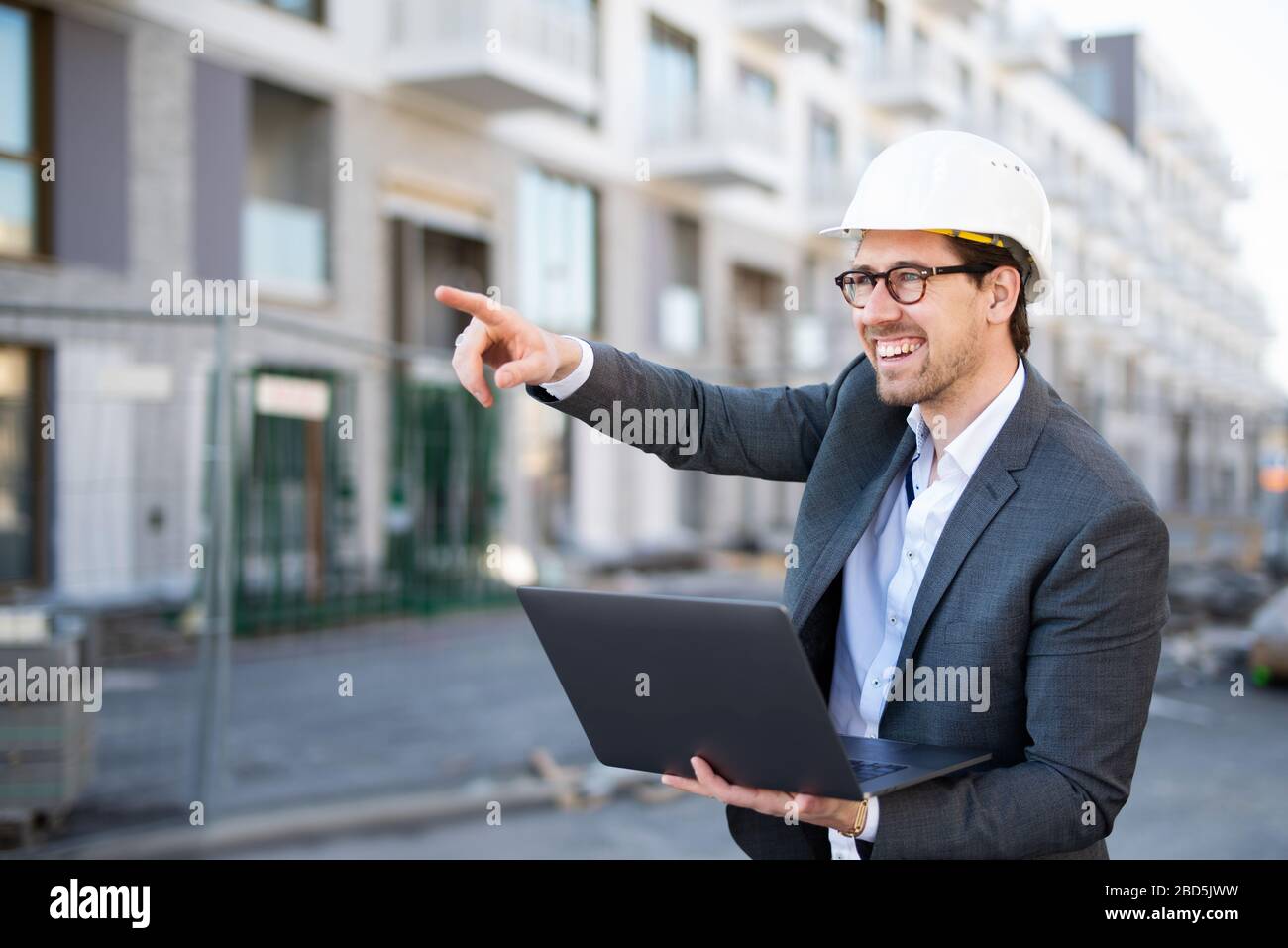 Young and attractive architect / civil engineer at work on a ...