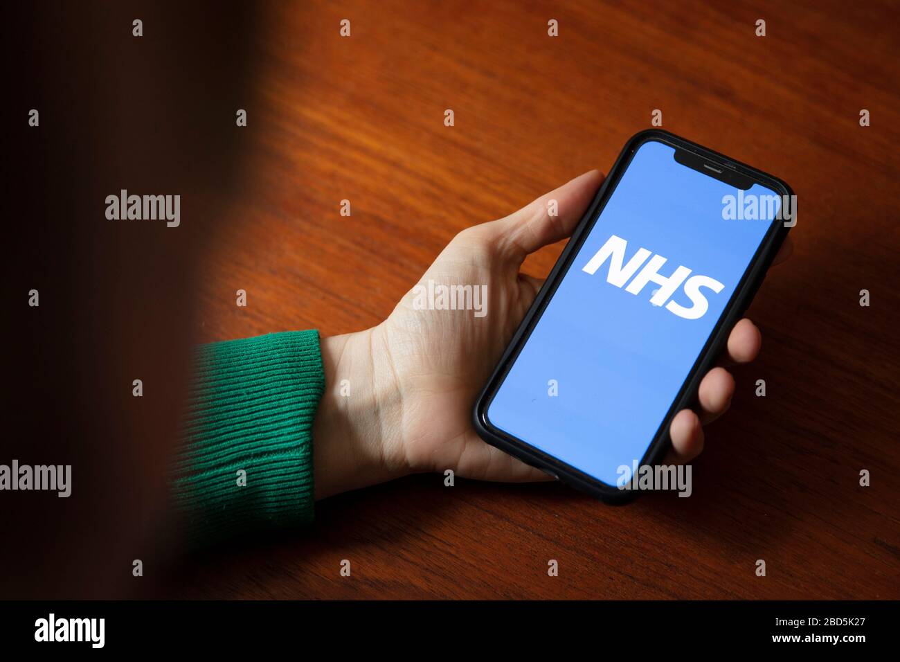 LONDON, UK - April 6th 2020: A person using the NHS healthcare ...