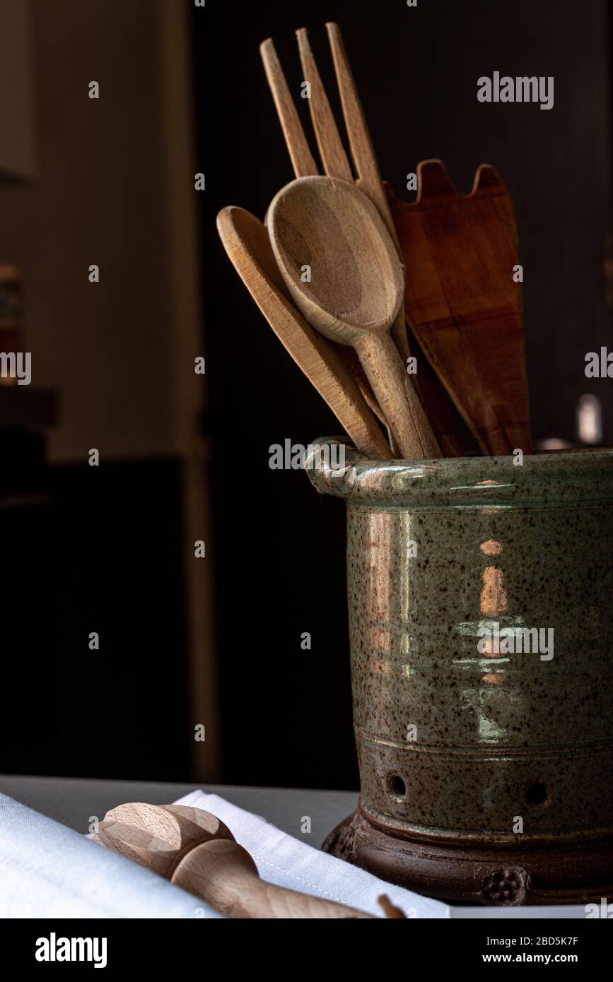 Zero waste kitchen wooden kitchen utensils in ceramic pot in kitchen ...