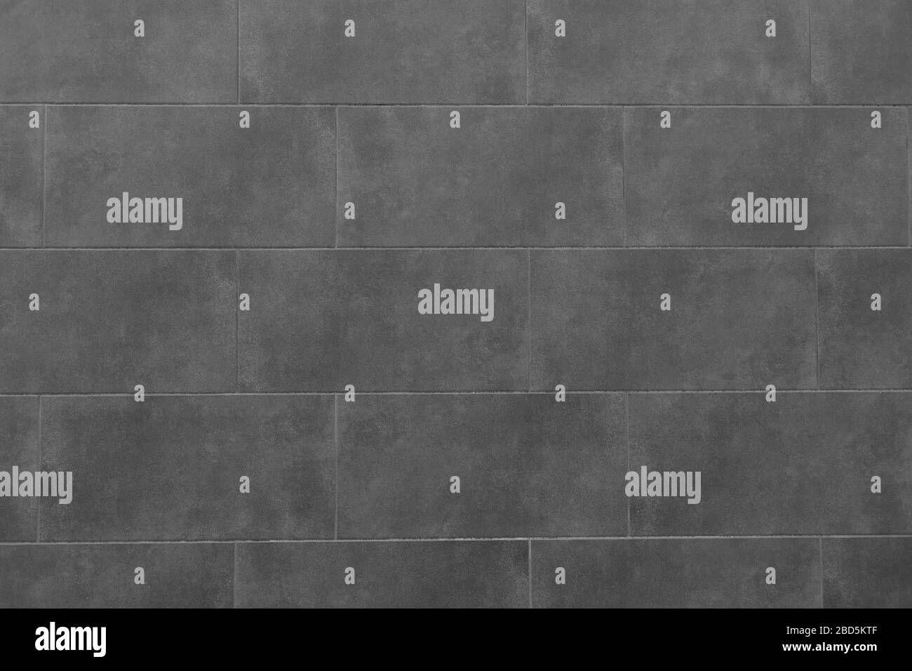 The texture of the black tile wall. Background of black tiled wall ...