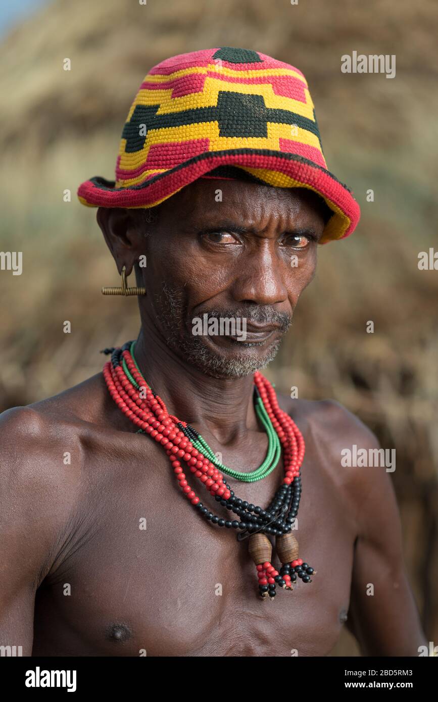 Sporting copper earnings and hand knit cap, Kora Aska, Hamer tribe or ...