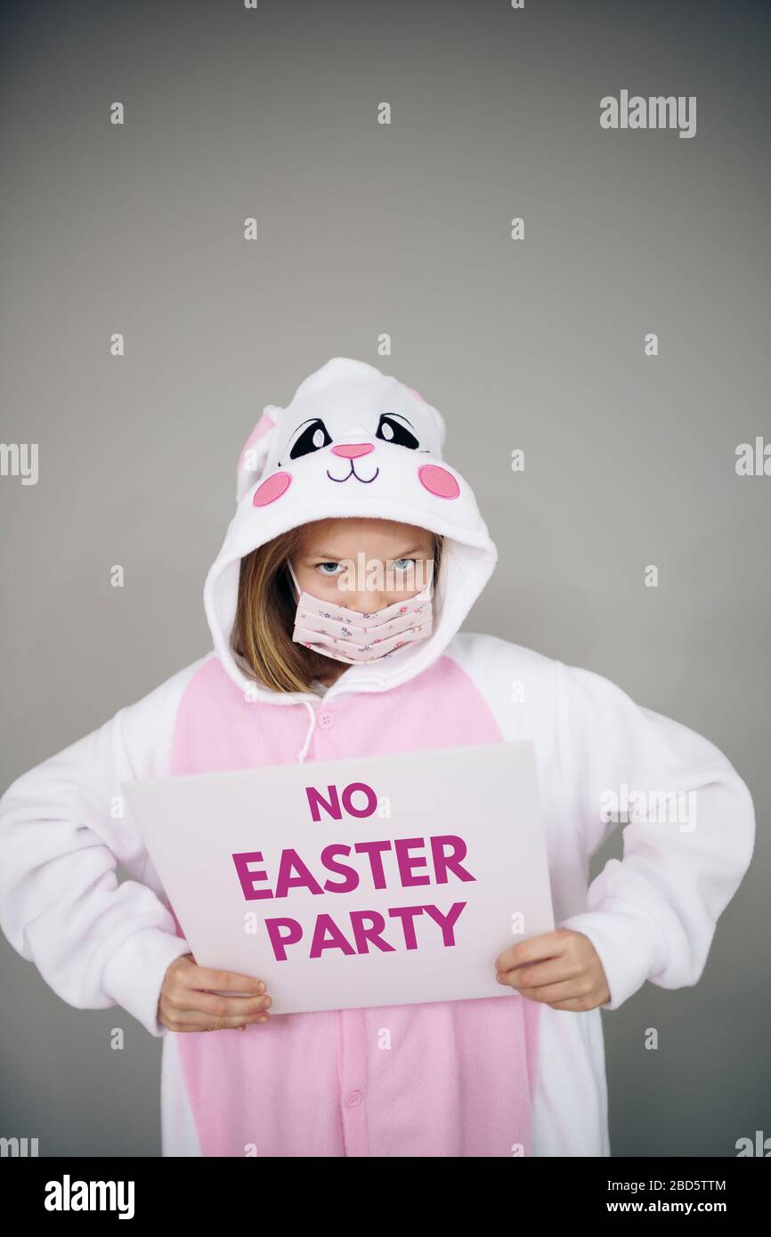 beautiful girl dressed as easter bunny with face protective mask ...