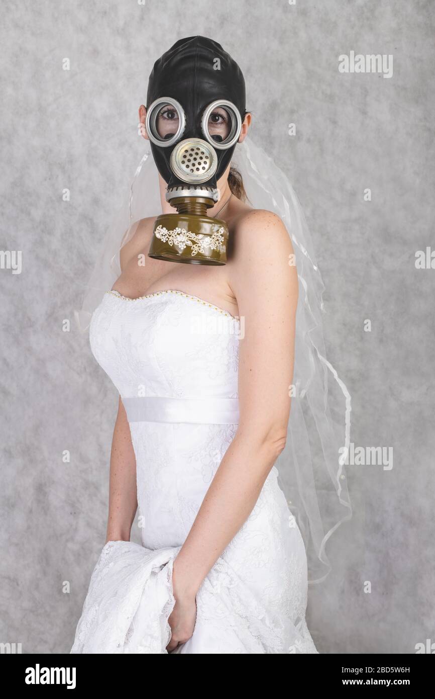 cyberpunk Bride in veil dress and protective gas mask and veil posing ...