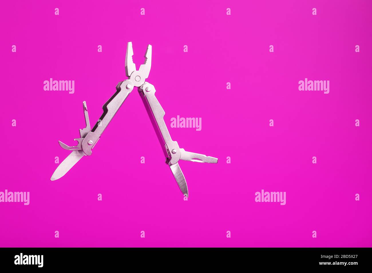 Multitool is a multi-functional tool on a pink background. The concept ...