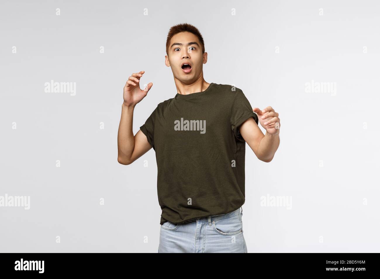 Portrait of alarmed and scared, shocked asian guy gasping, step back ...