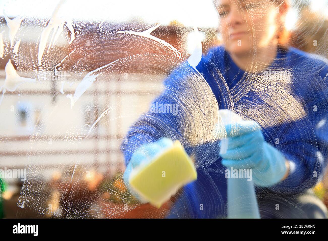 housekeeping: cleaning the windows, Window cleaner using a squeegee ...