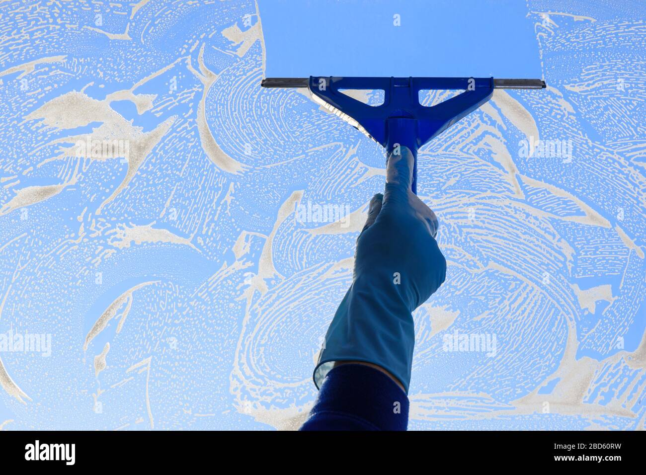 housekeeping: cleaning the windows, Window cleaner using a squeegee ...